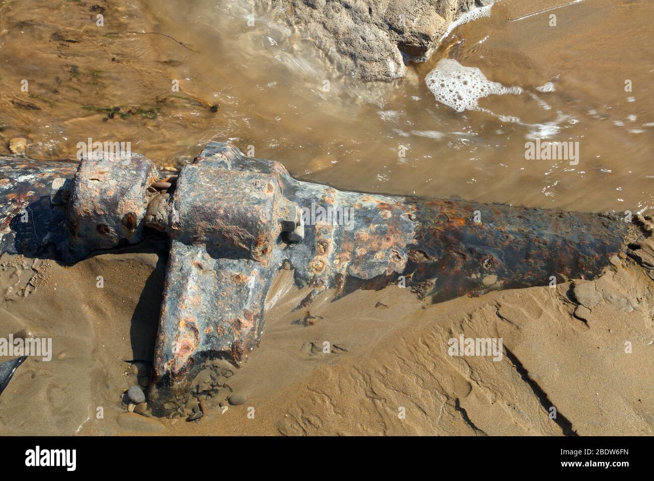 Buried in the sands of the local beach this old sewage outfall pipe is ...