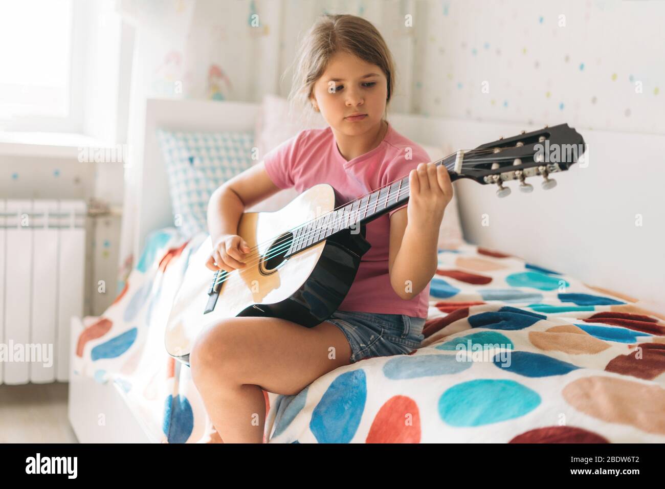 Preteen girl playing musical instrument hi-res stock photography and ...