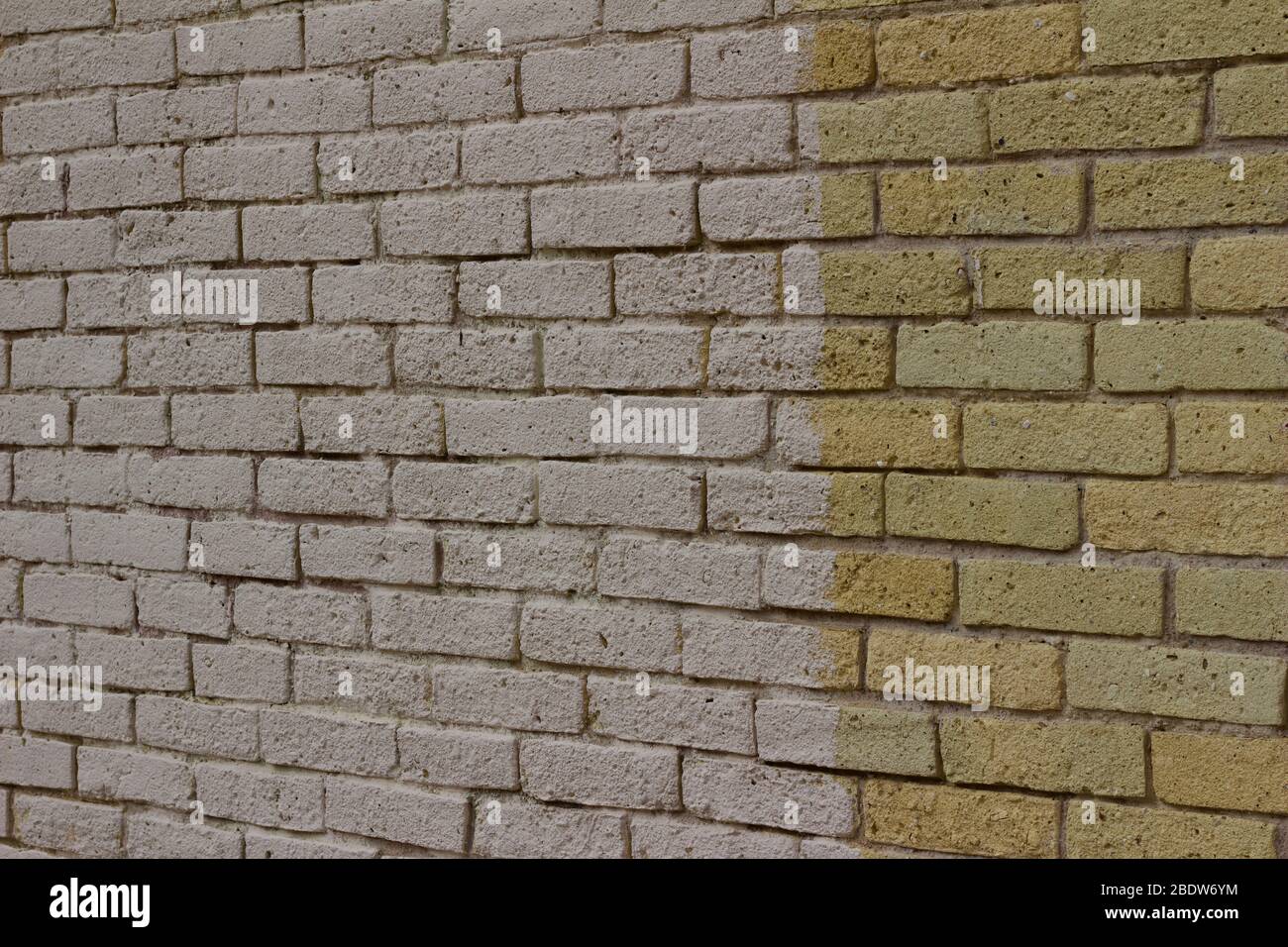 Shabby chic old yellow brick wall texture background, showing a pitted ...