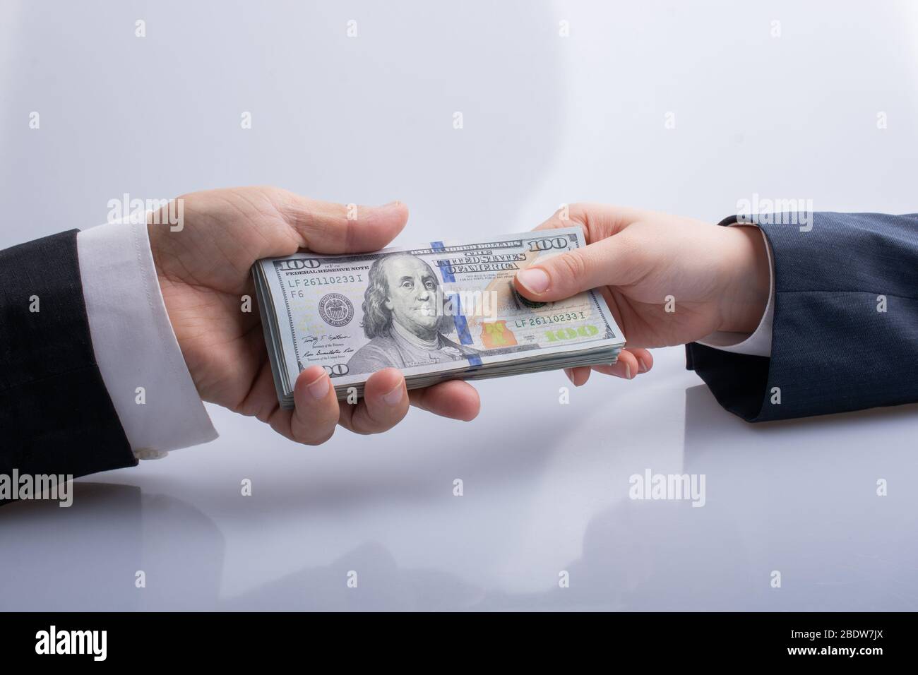 Businessman giving and receiving US dollar banknote money Stock Photo ...