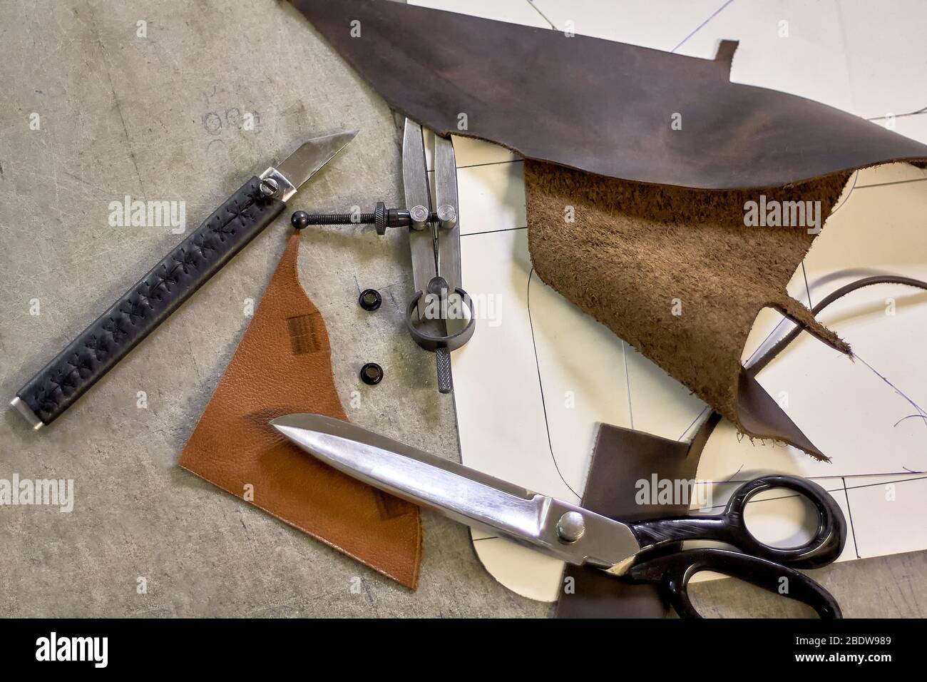 Leather crafting DIY tools and templates on workbench. Fittings and ...