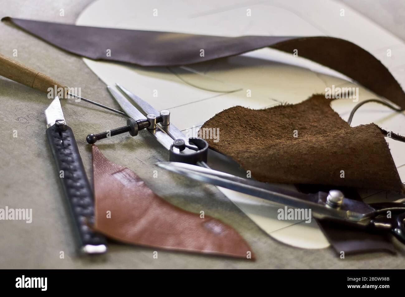 Leather crafting DIY tools and templates on workbench. Fittings and ...