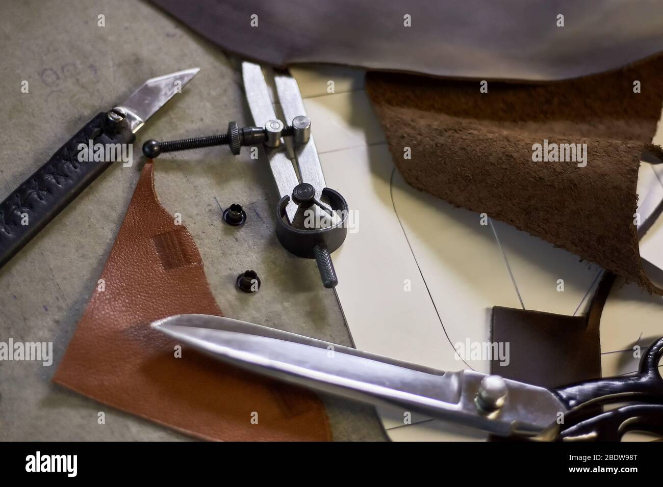 Leather crafting DIY tools and templates on workbench. Fittings and ...