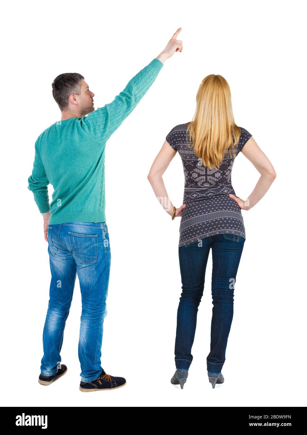 Back view of couple in sweater pointing. Rear view people collection ...