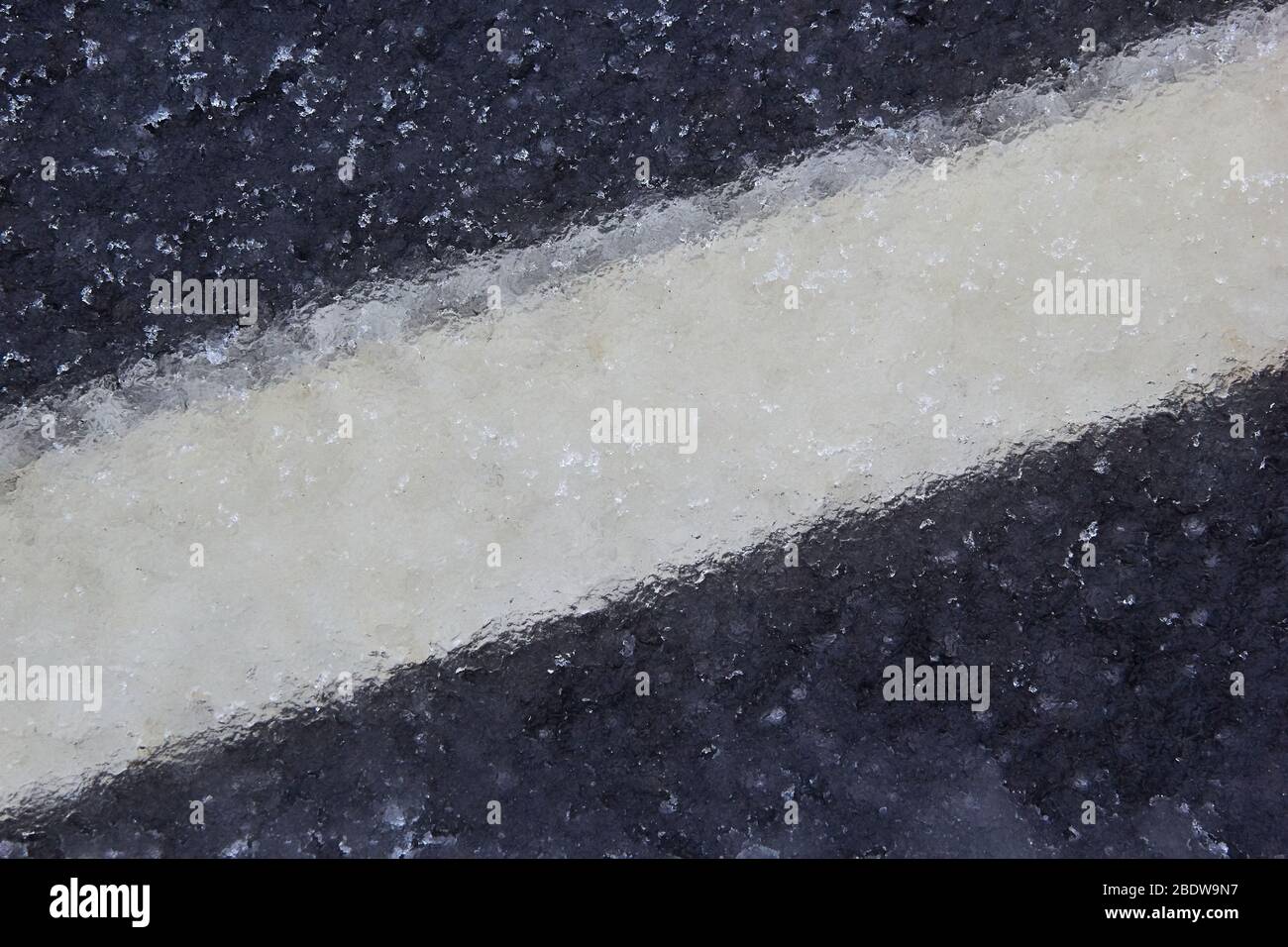 asphalt texture hidden under a layer of wet snow Stock Photo - Alamy