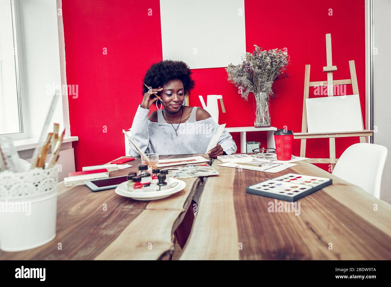 Relaxed young female person creating interesting project Stock Photo ...