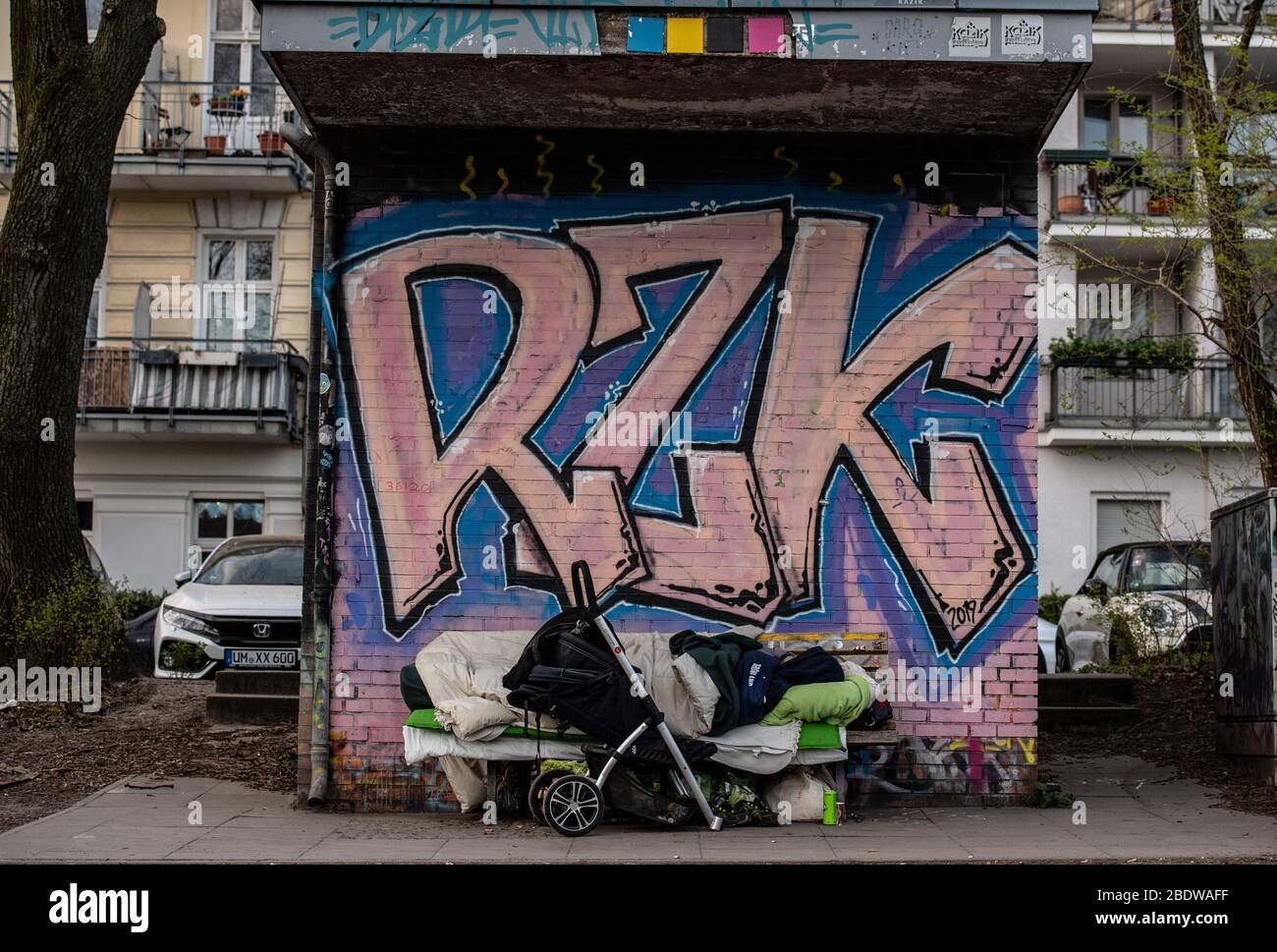 Berlin, Germany. 10th Apr, 2020. A homeless man sleeps on a bench near ...