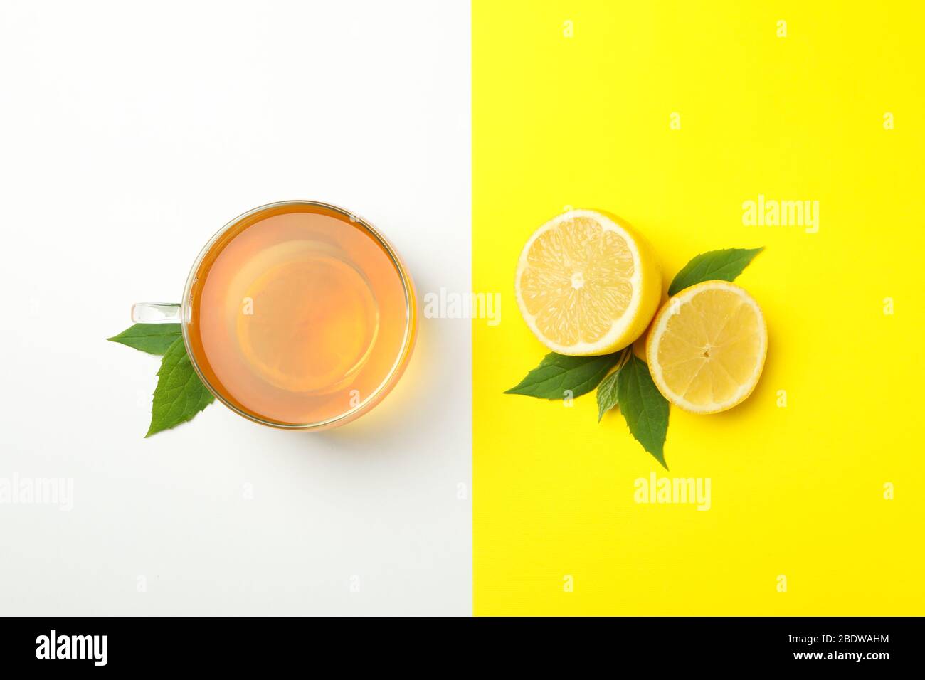 Tea and lemon on two tone background, top view. Ripe fruit Stock Photo ...