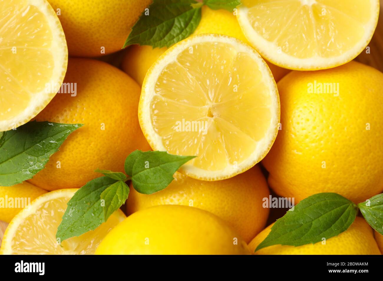 Lemons with leaves on whole background, close up. Ripe fruit Stock ...