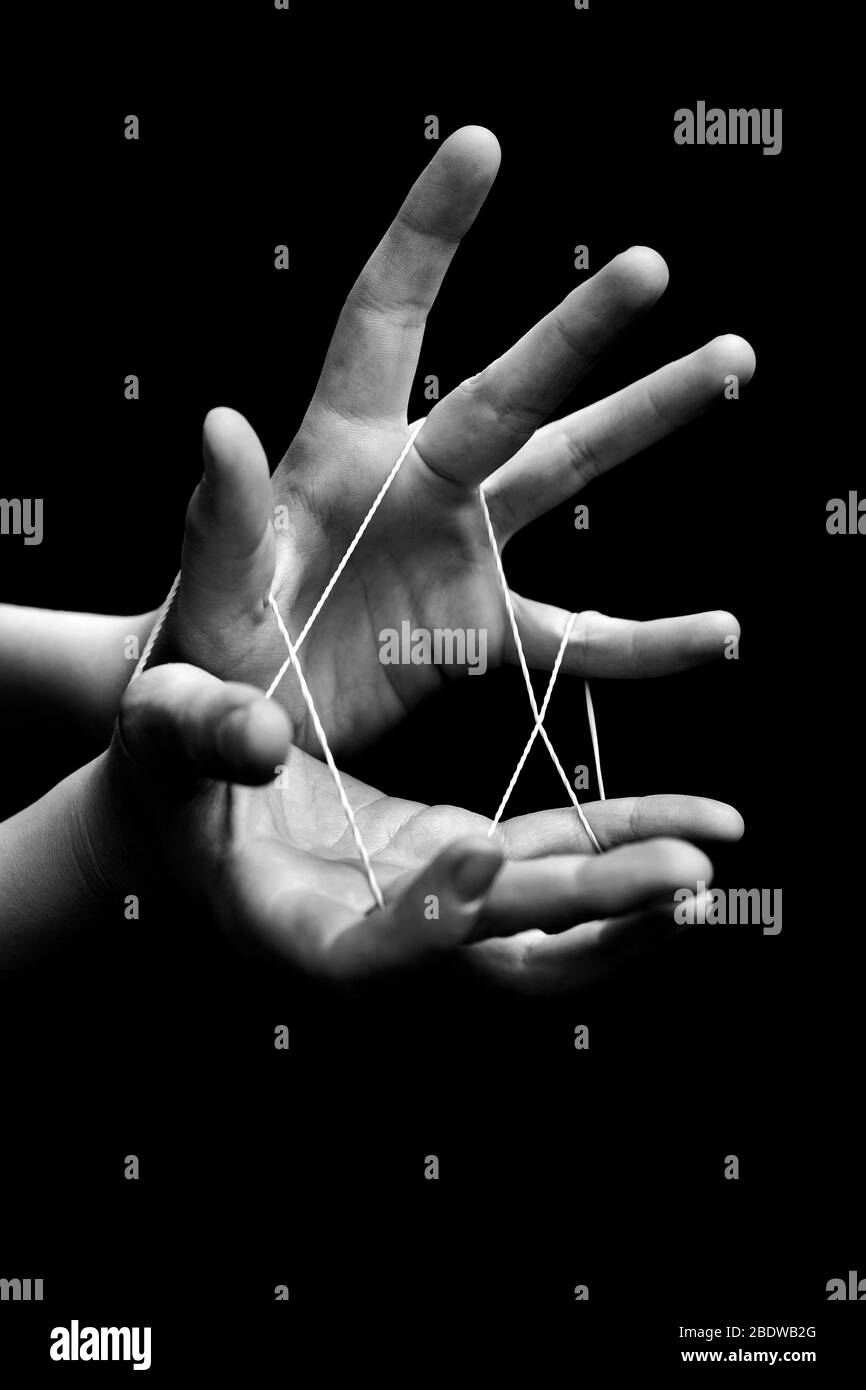 Two hands perform elastic band trick Stock Photo - Alamy