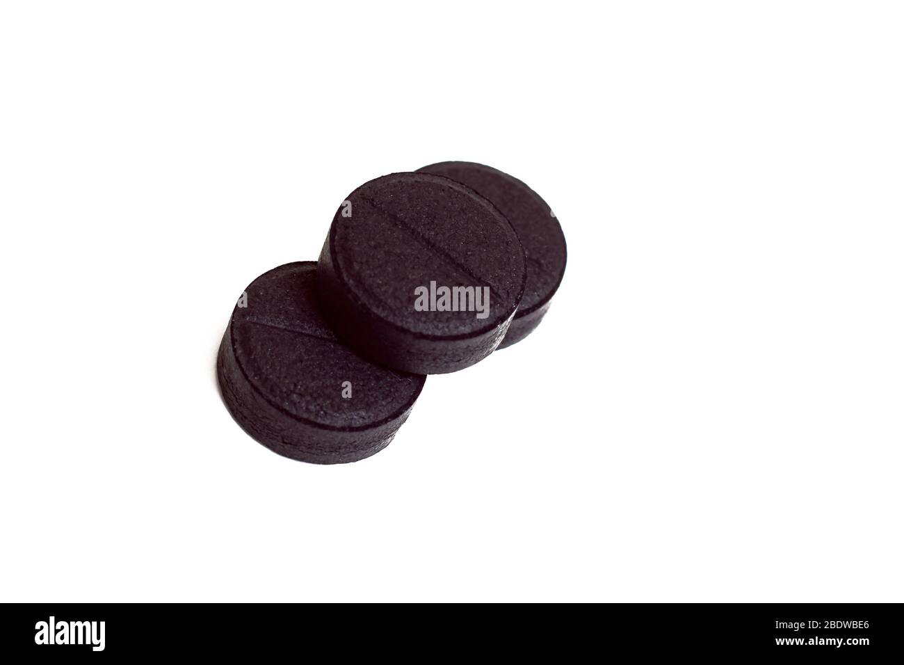 Three black charcoal tablets isolated on white background Stock Photo ...