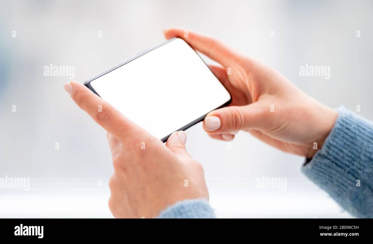 Hand holding mobile phone with white screen Stock Photo - Alamy