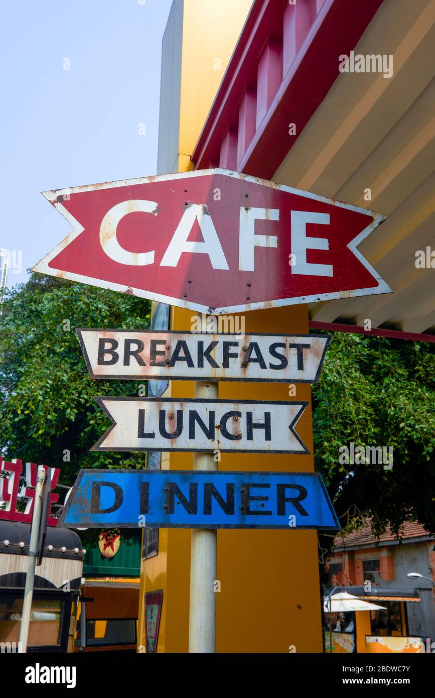 A set of street signs with coffee, breakfast, lunch, and dinner signs ...