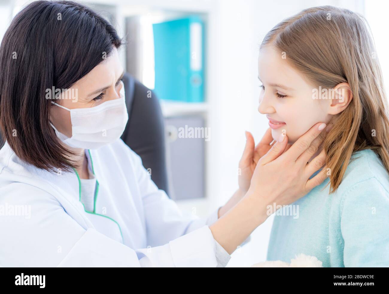 Doc checking lymph nodes of little patient Stock Photo - Alamy