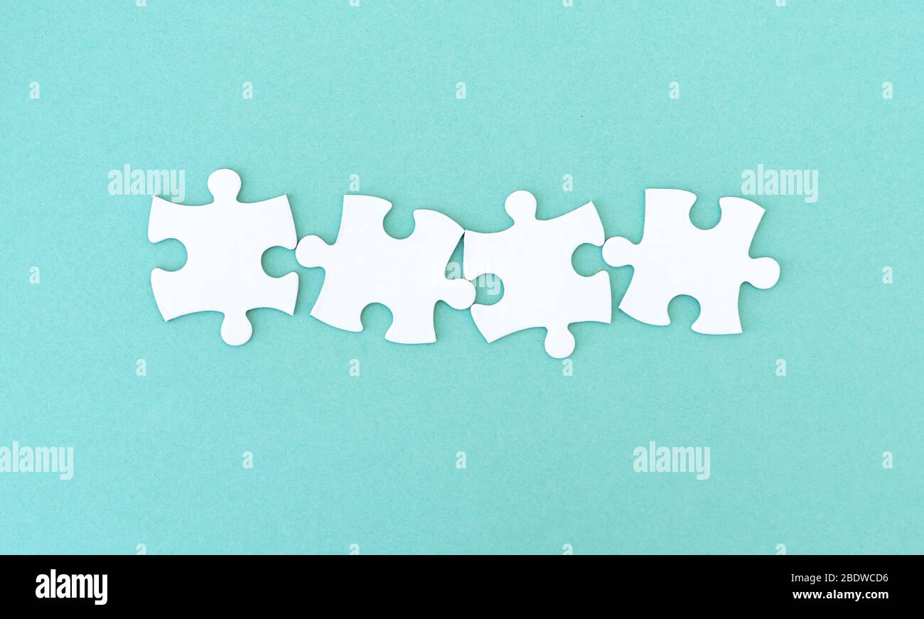 Jigsaw puzzle pieces in a row for inscription, 4 pieces Stock Photo - Alamy