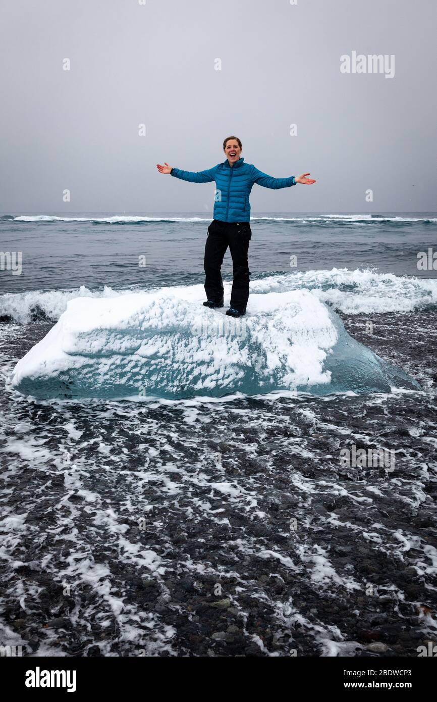 Portrait of a woman posing on a small iceberg in Iceland Stock Photo ...