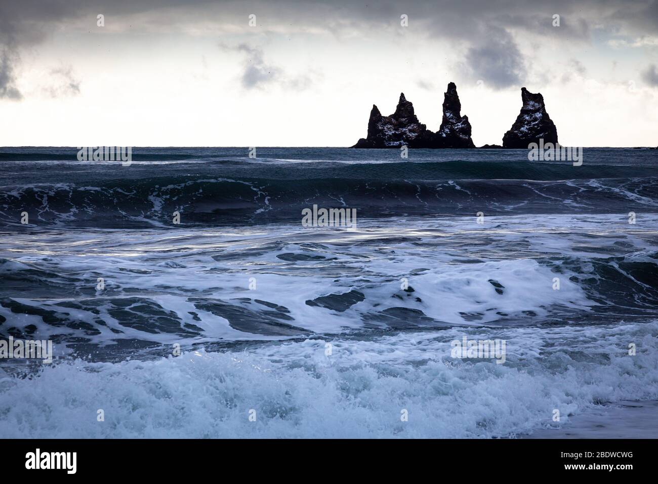 Reynisdrangar basalt sea stacks in winter at Vík í Mýrdal on Iceland's ...