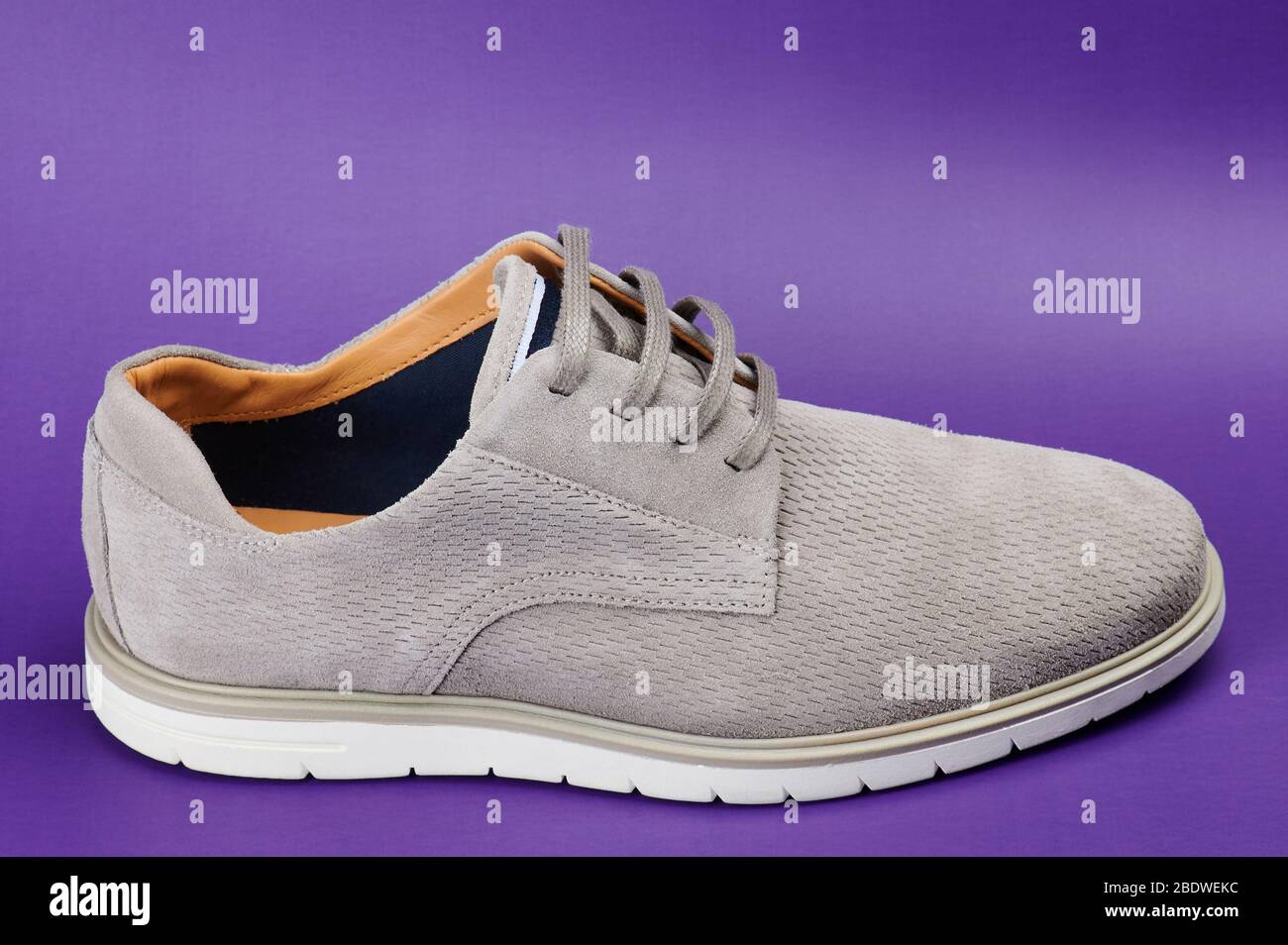 Gray casual man shoe side view isolated on purple background Stock ...
