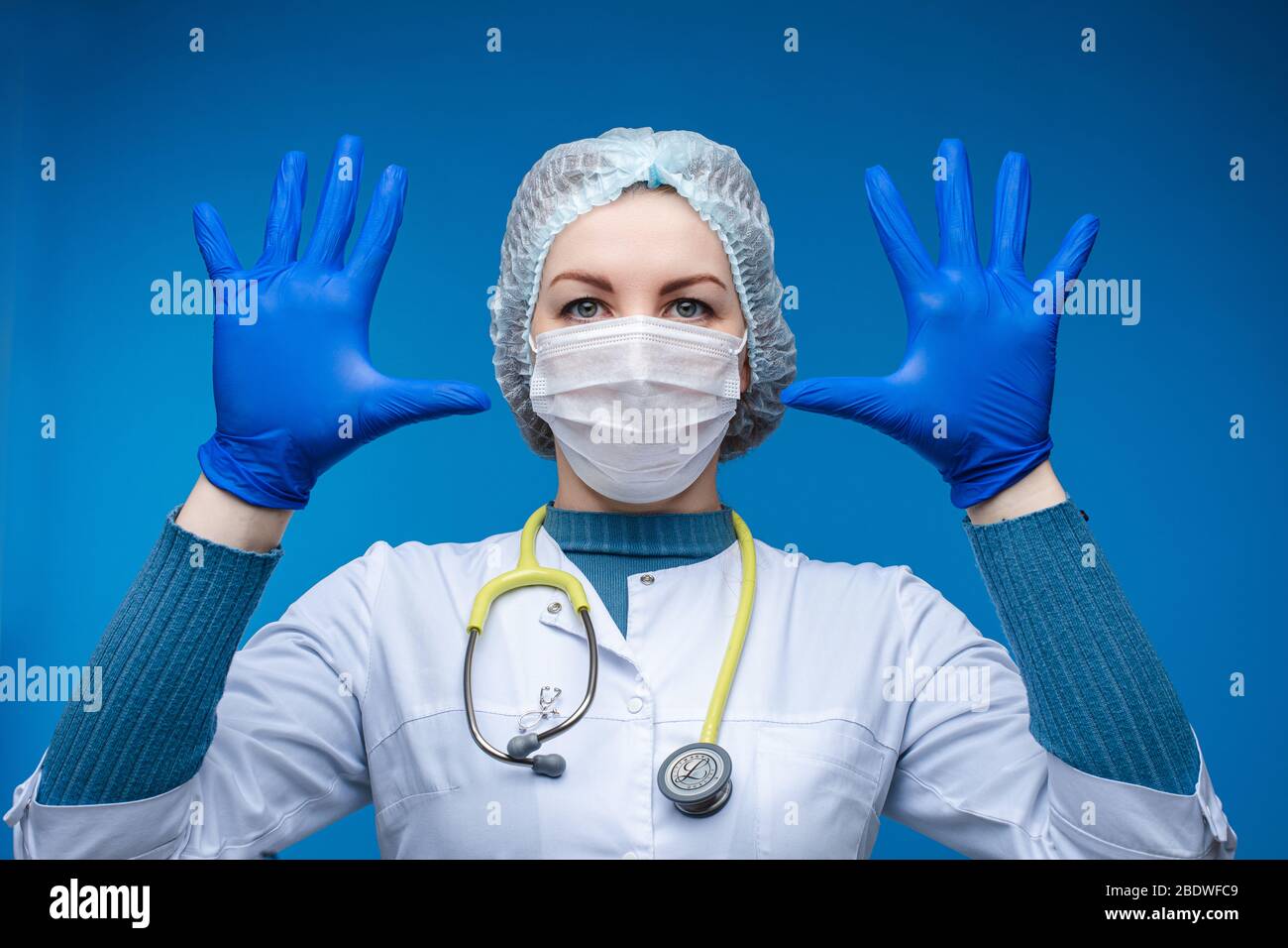 Doctor showing her hands in blue protection gloves Stock Photo - Alamy