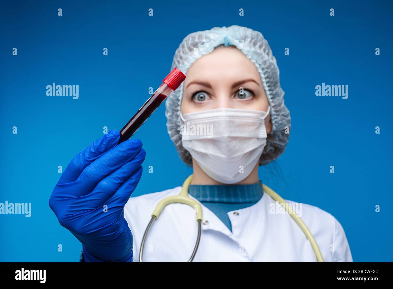 Lab worker with blood test tube in hand Stock Photo - Alamy