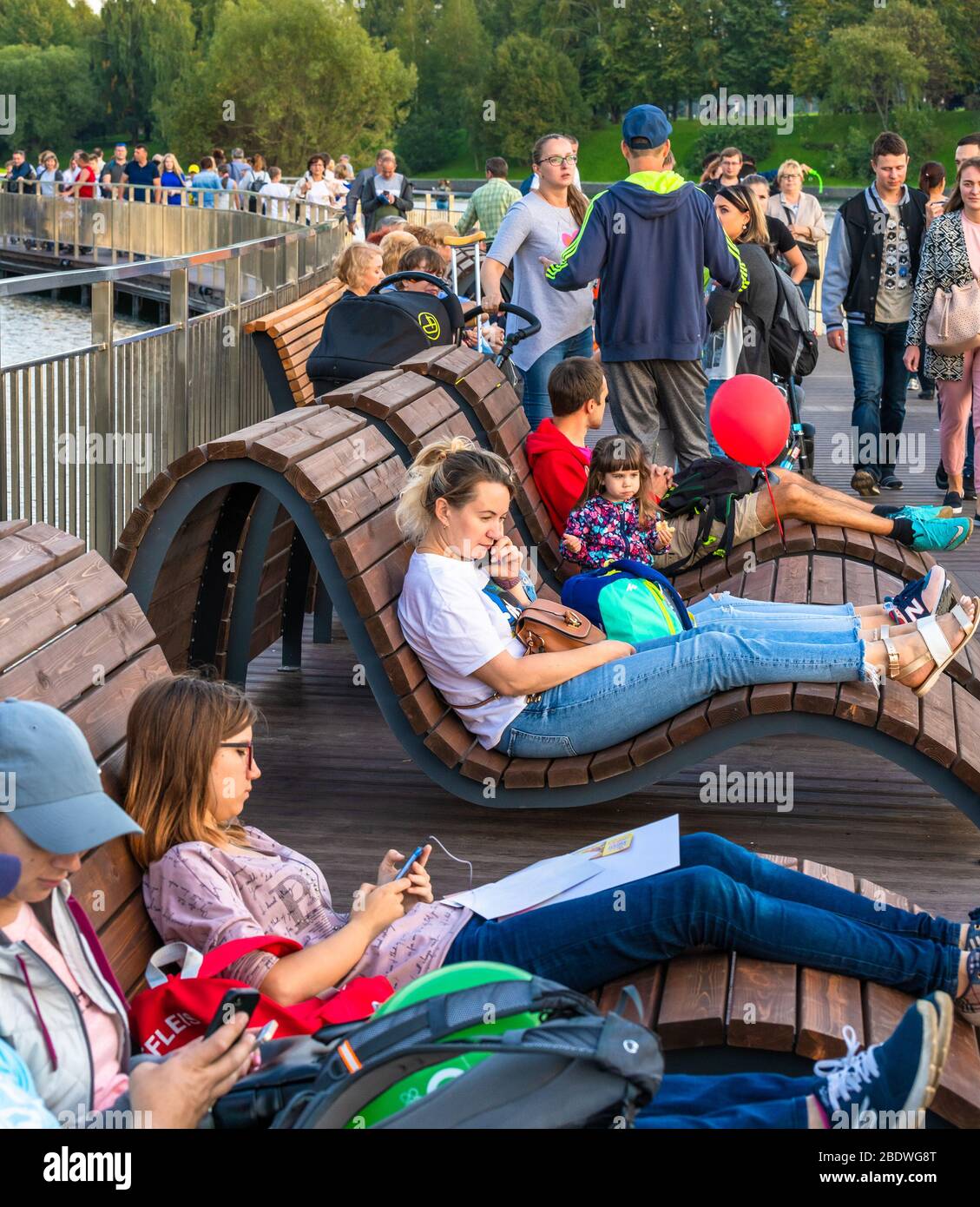 Moscow, Russia - Sept 7. 2019. People sit on benches during celebration ...