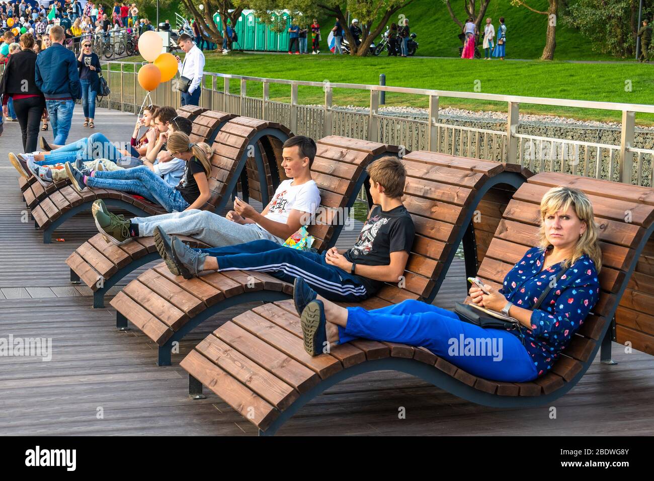 Moscow, Russia - Sept 7. 2019. People sit on benches during celebration ...