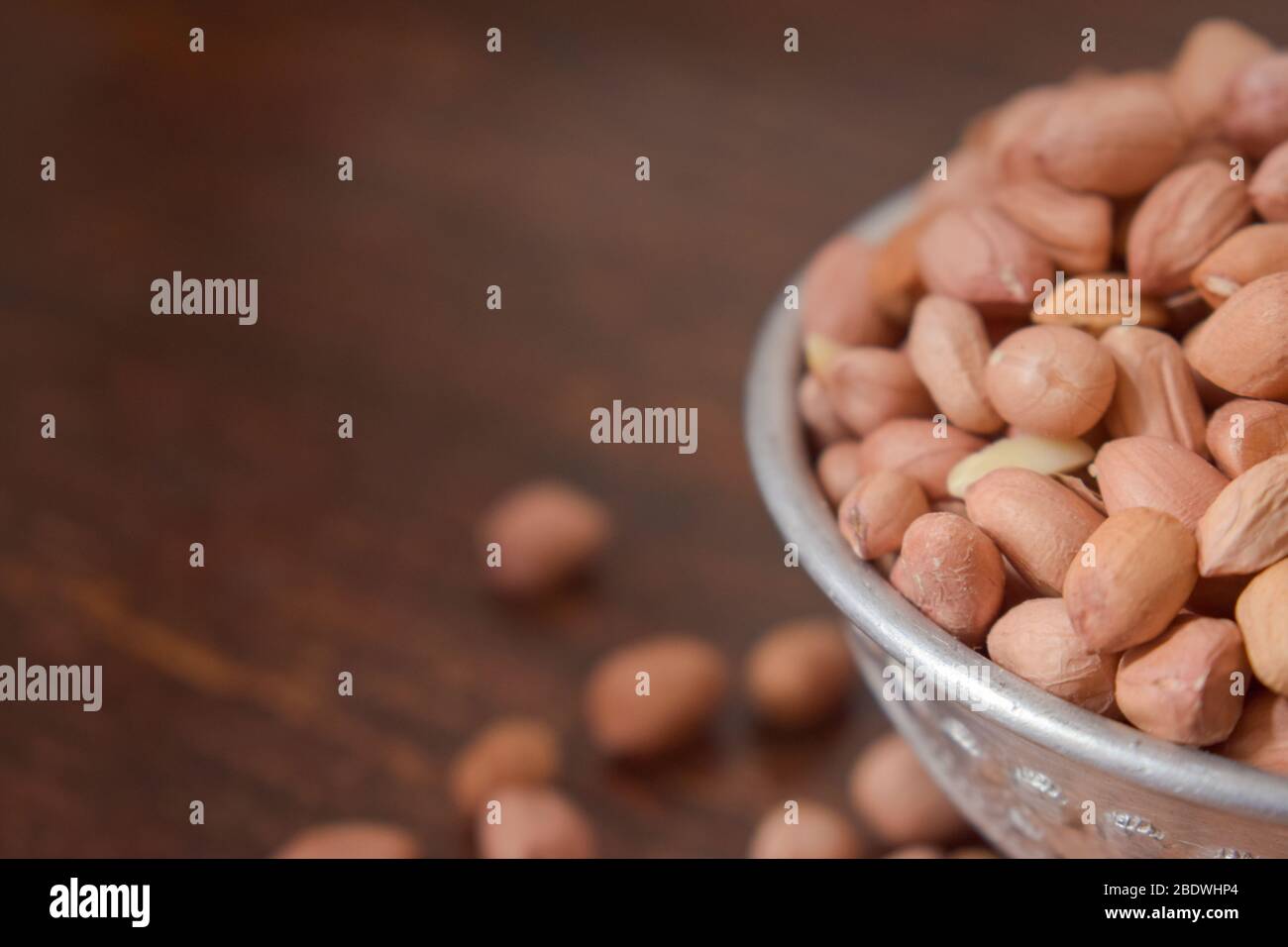 Peeled peanuts in a Silver bowl on wooden old Table. rustic style Stock Photo - Alamy