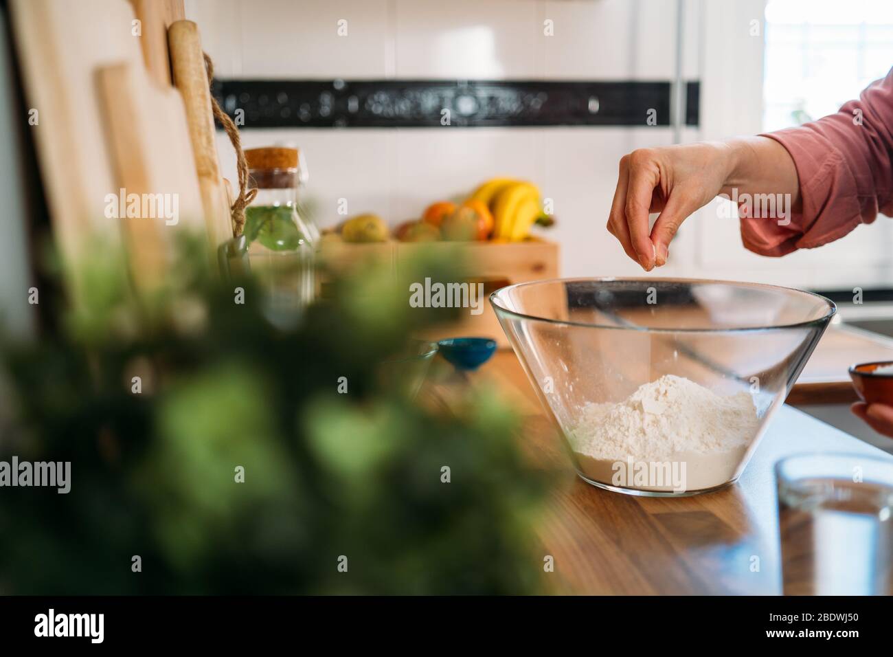 Woman adding salt to food hi-res stock photography and images - Alamy