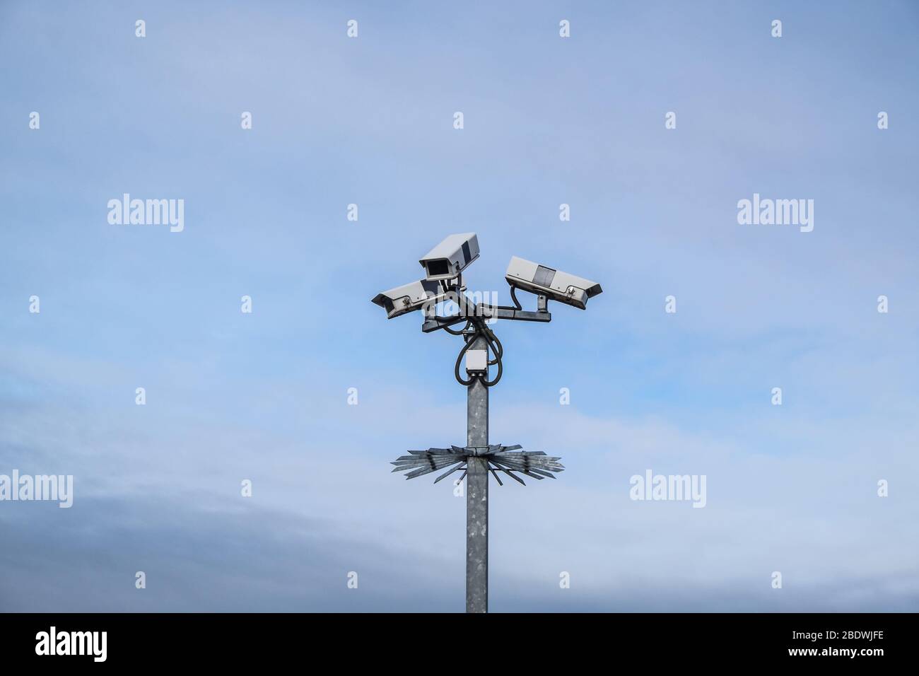 Security surveillance cameras on a metal post with spikes in England ...