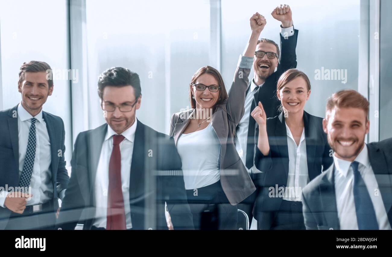 triumphant business team standing in the conference room Stock Photo ...
