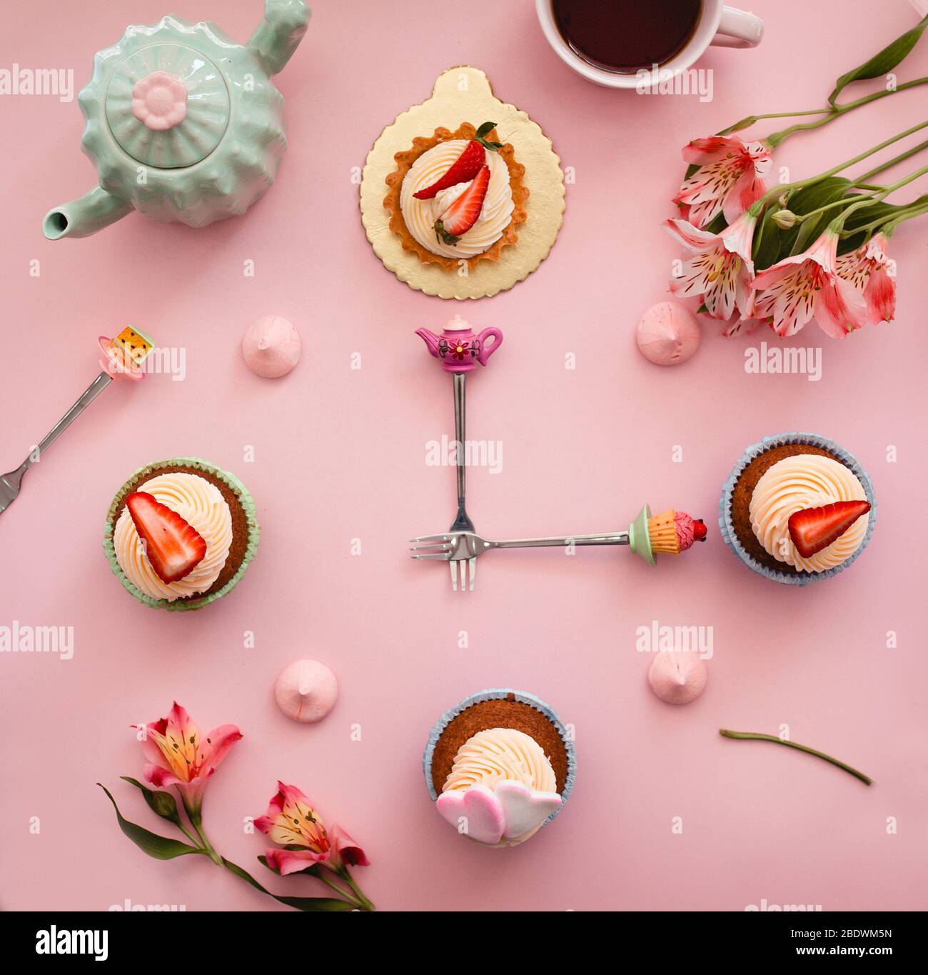 sweet clock from cakes with strawberries Stock Photo - Alamy