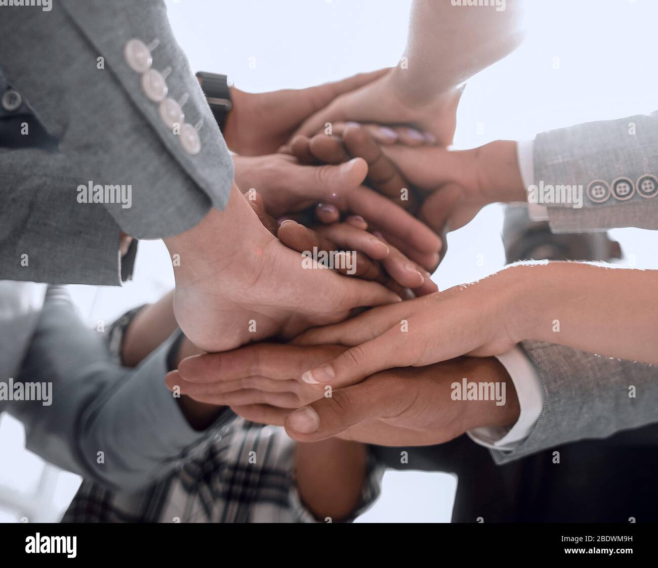 Closeup of a business colleagues with their hands stacked together ...