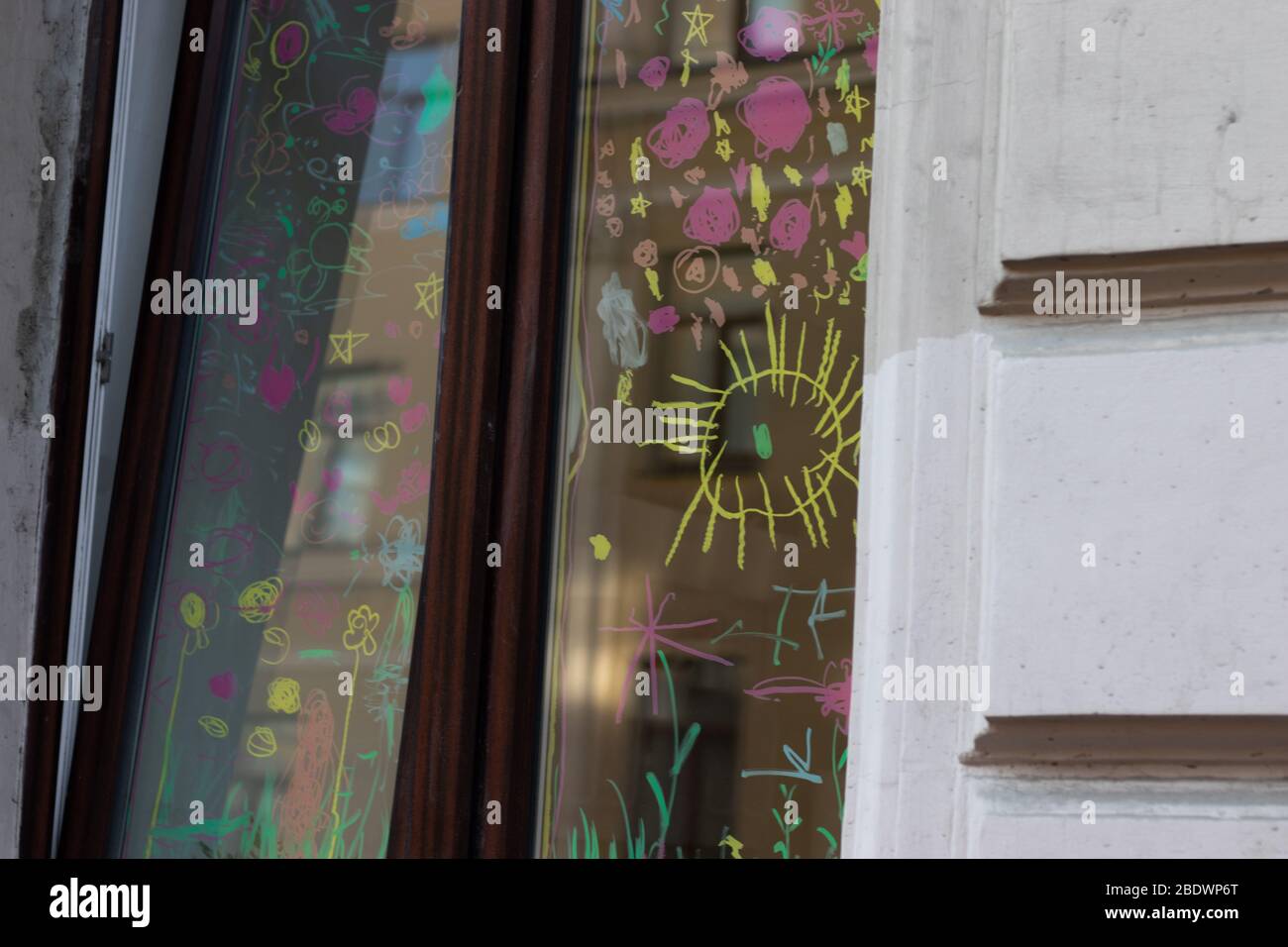 Children's bright different drawings made by hands on the glass of ...