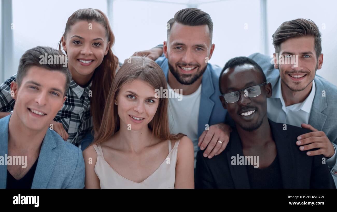 Group of young executives smiling at camera during a work meeting Stock ...