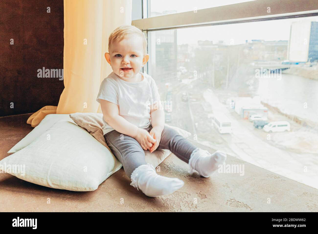 Stay Home Stay Safe. Little cute sweet infant little baby girl sitting ...