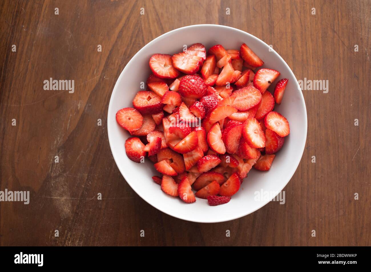high angle view of sliced straberries in a white plate. Great copy ...