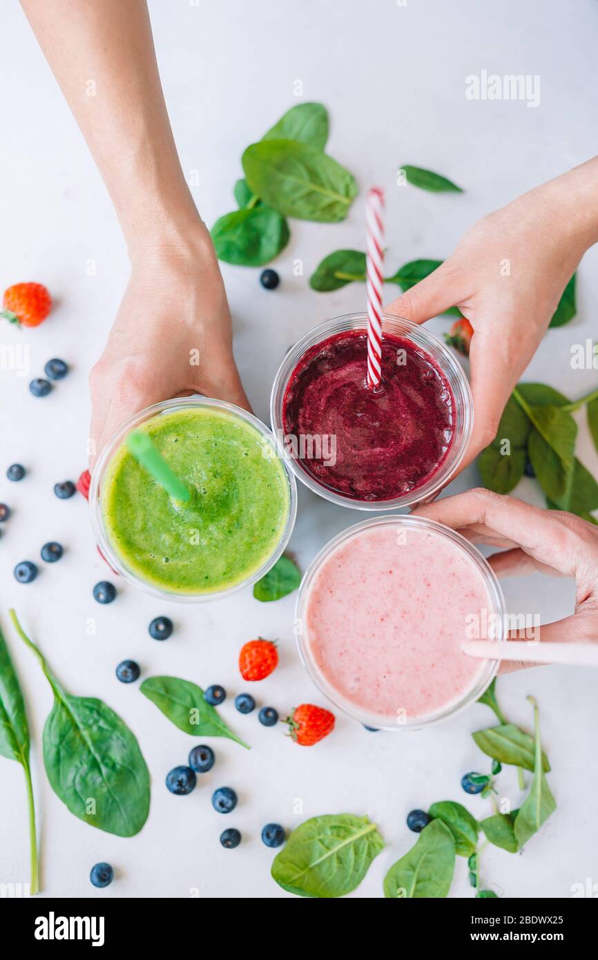 Row of healthy fresh fruit and vegetable smoothies with assorted ...