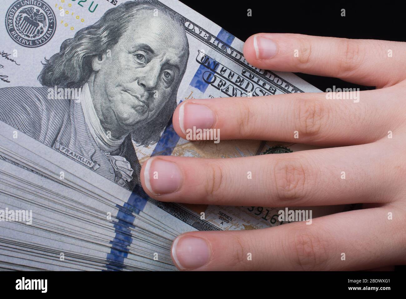 Hand holding American dollar banknotes isolated on white background ...