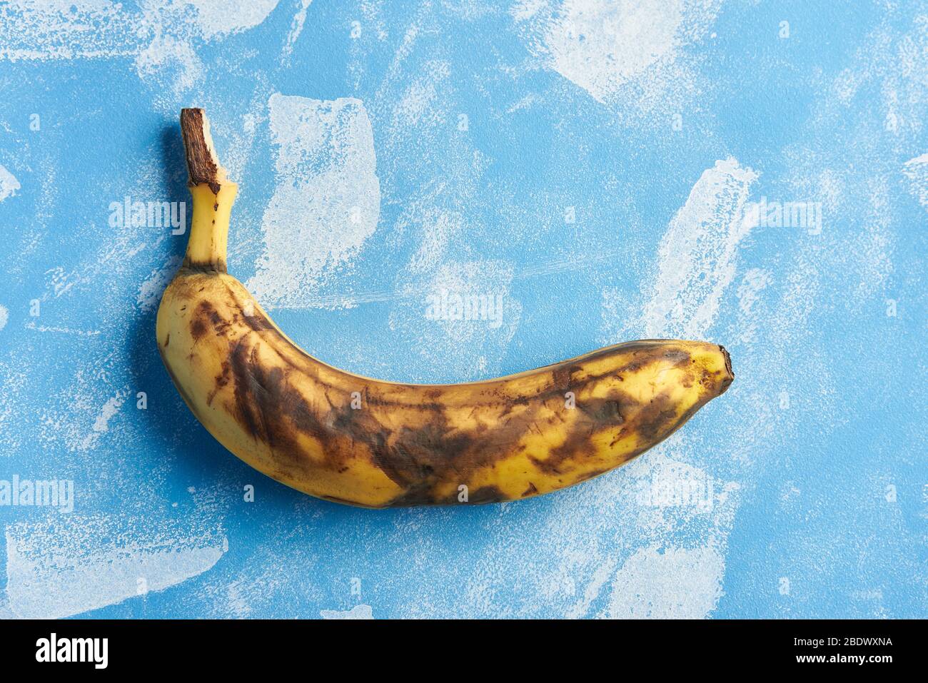 rotten bananas on a blue background. view from above Stock Photo - Alamy
