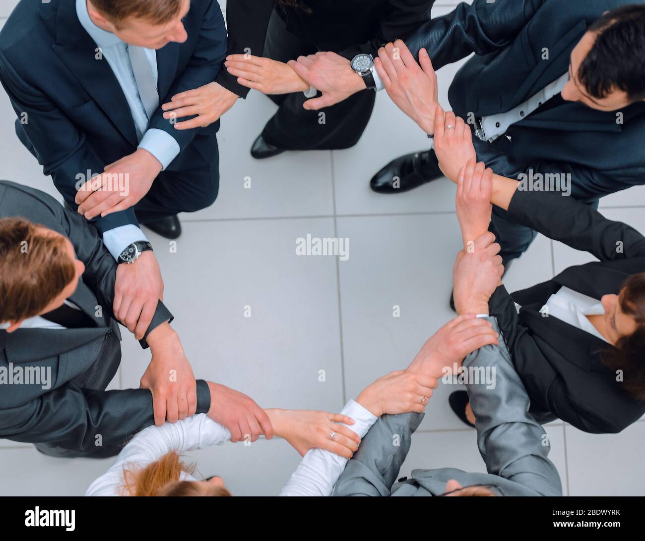 closeup. hands business team form a circle Stock Photo - Alamy