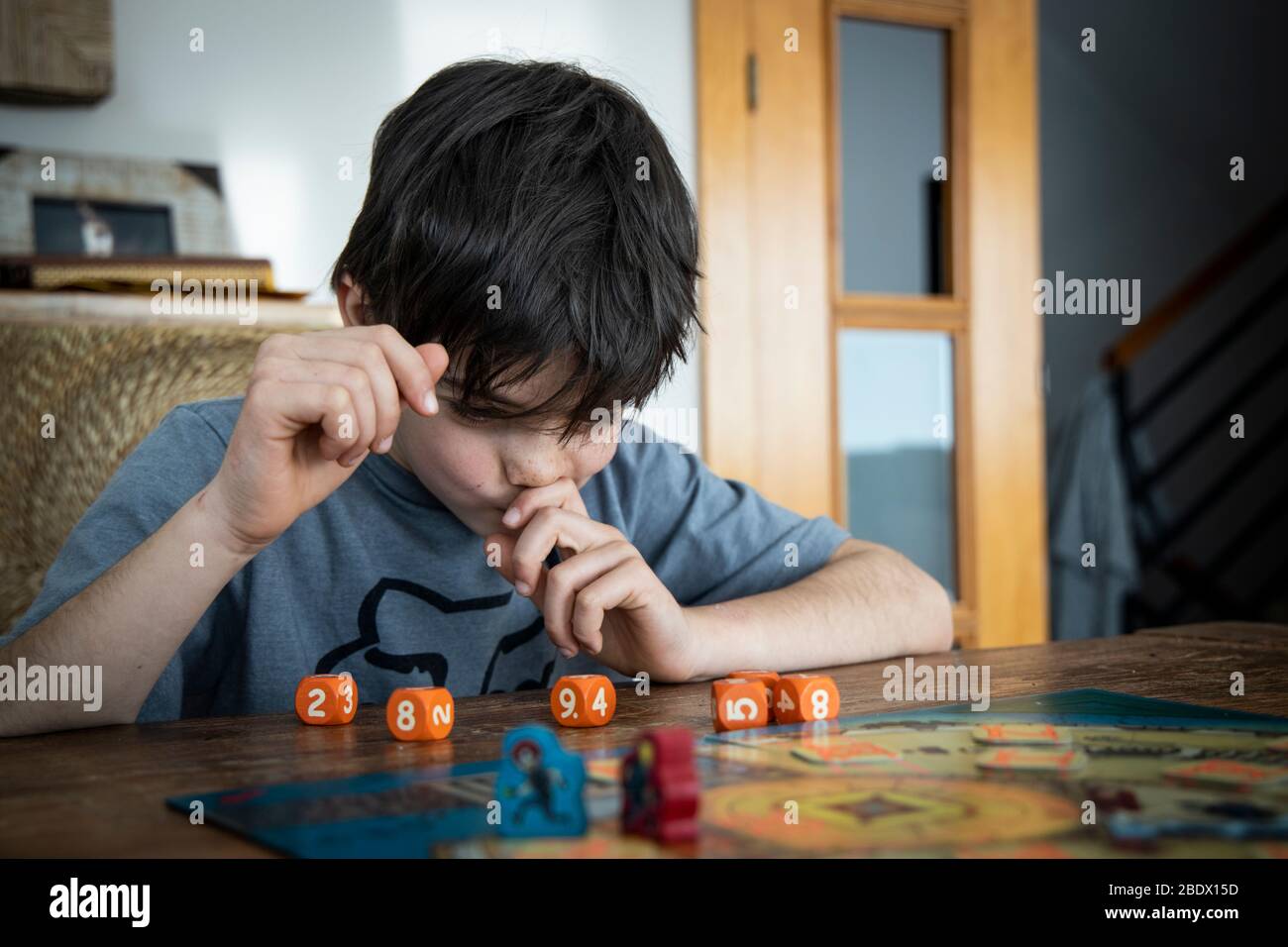 Boy playing board game during Covid19 confinement in Catalonia, Spain ...