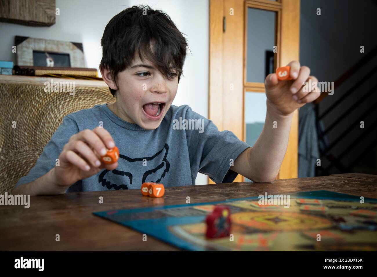 Boy playing board game during Covid19 confinement in Catalonia, Spain ...