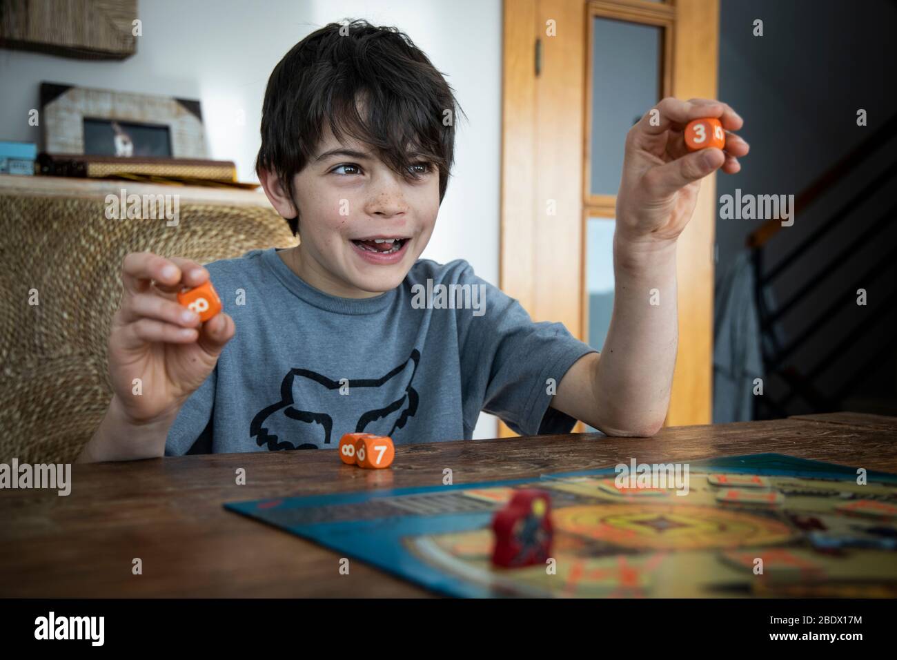 Boy playing board game during Covid19 confinement in Catalonia, Spain ...