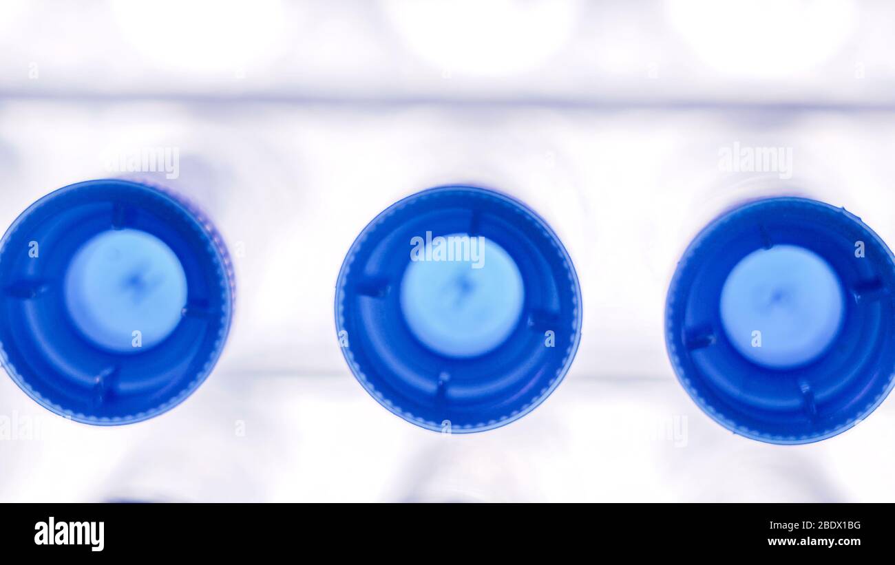A look of the blue caps of the test tubes seen from the glass tables ...