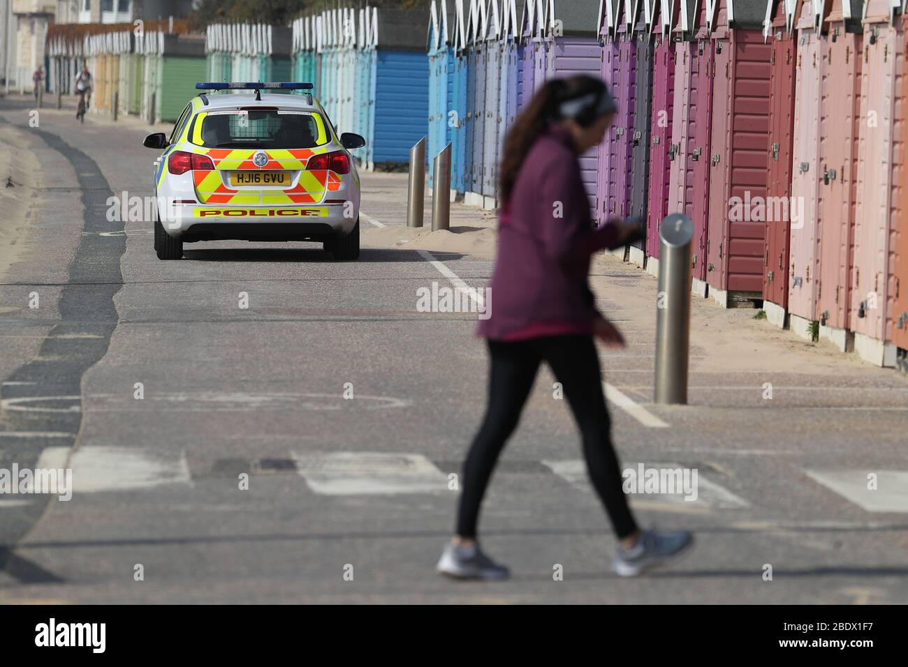 Police officers patrol the sea front in a police car on Bournemouth ...