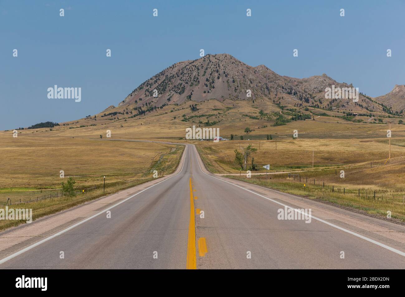 A Highway Leading To A Butte Stock Photo - Alamy