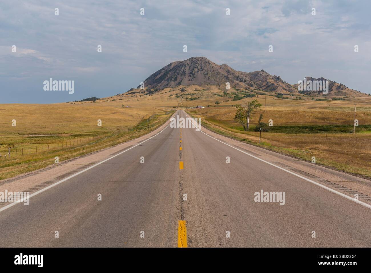 A Highway Leading To A Butte Stock Photo - Alamy