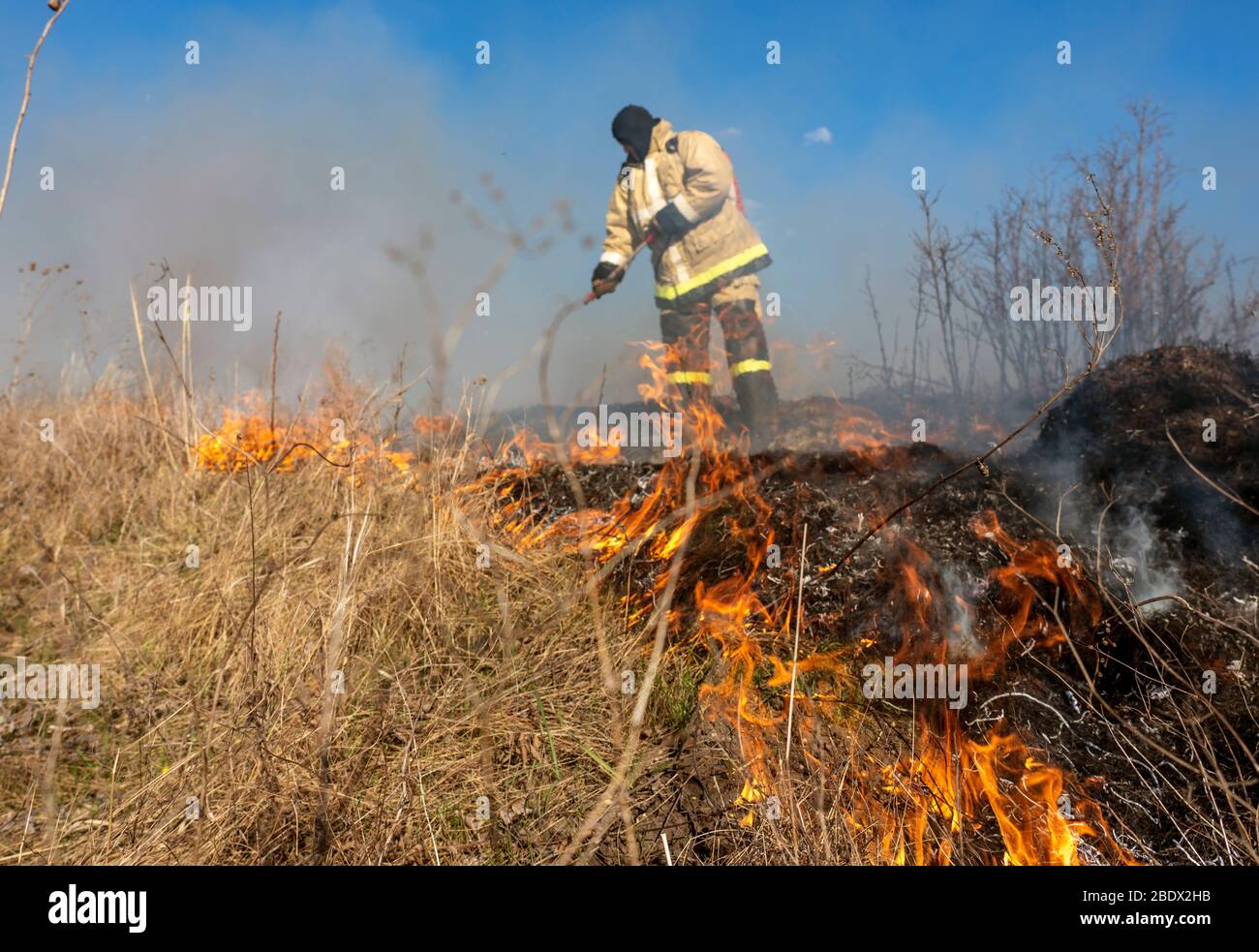 firefighters extinguish the flames of burning grass Stock Photo - Alamy