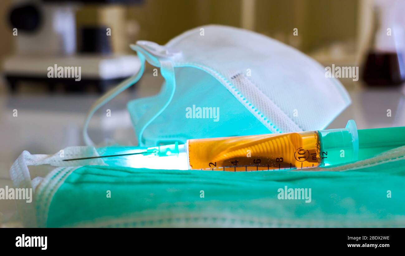 Closer look of the two surgical mask with the syringe inside the dark ...