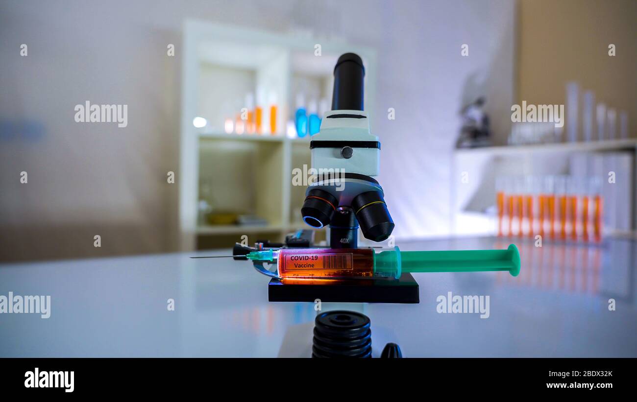 The small microscope and the coronavirus syringe vaccine with the covid ...